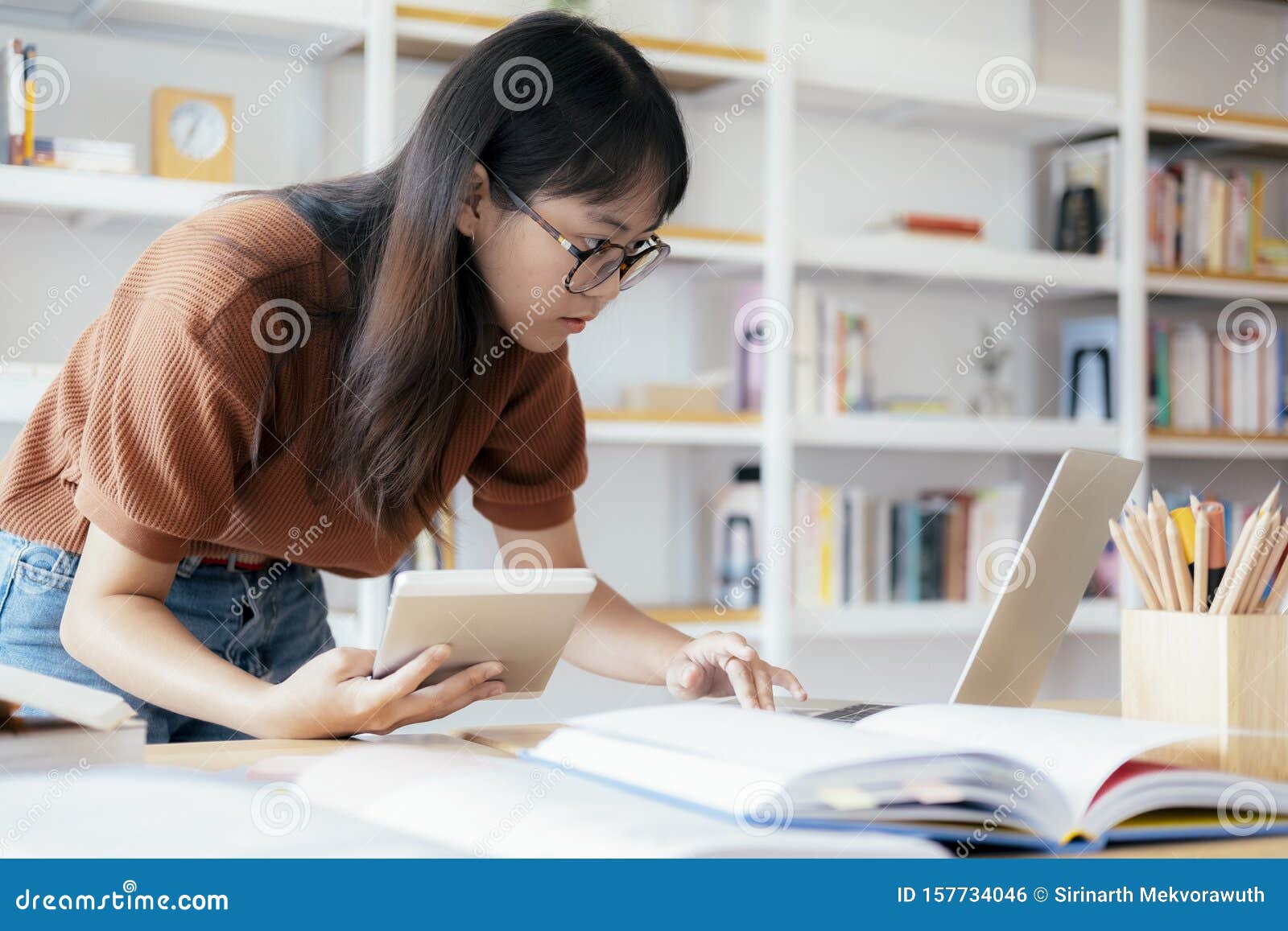 Young Collage Student Using Computer and Mobile Device Studying Online ...