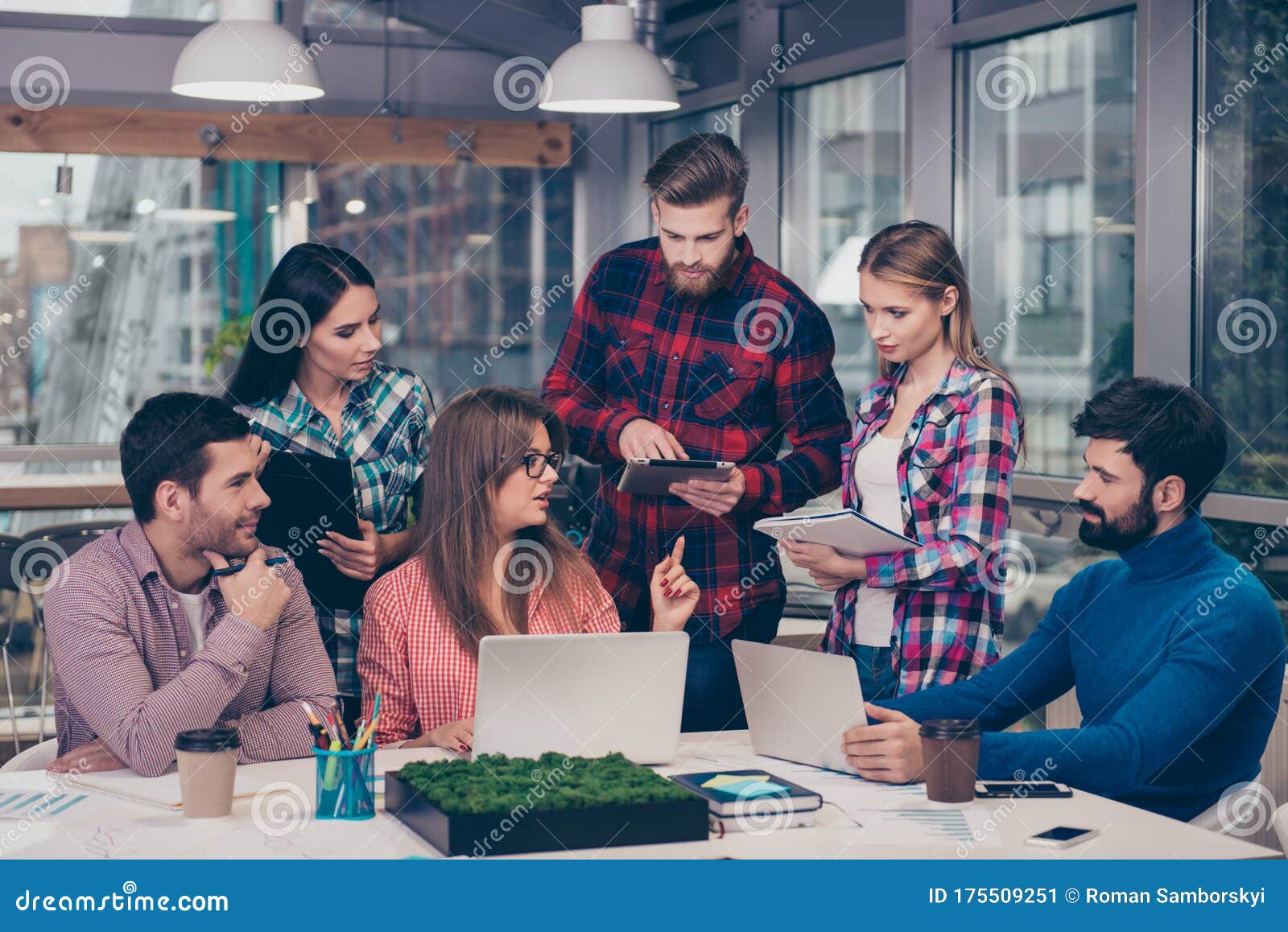 Young Colleagues Discussing Main Points of Presentation for Business ...