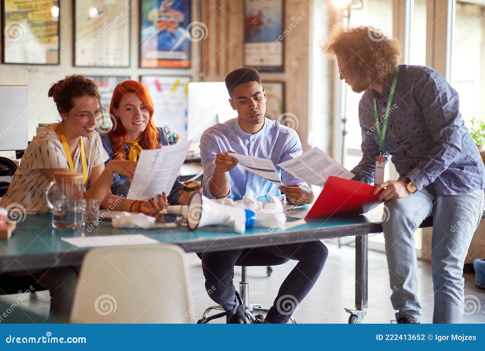 Young Colleagues are Inspecting Some Documents at Desk in the Office ...