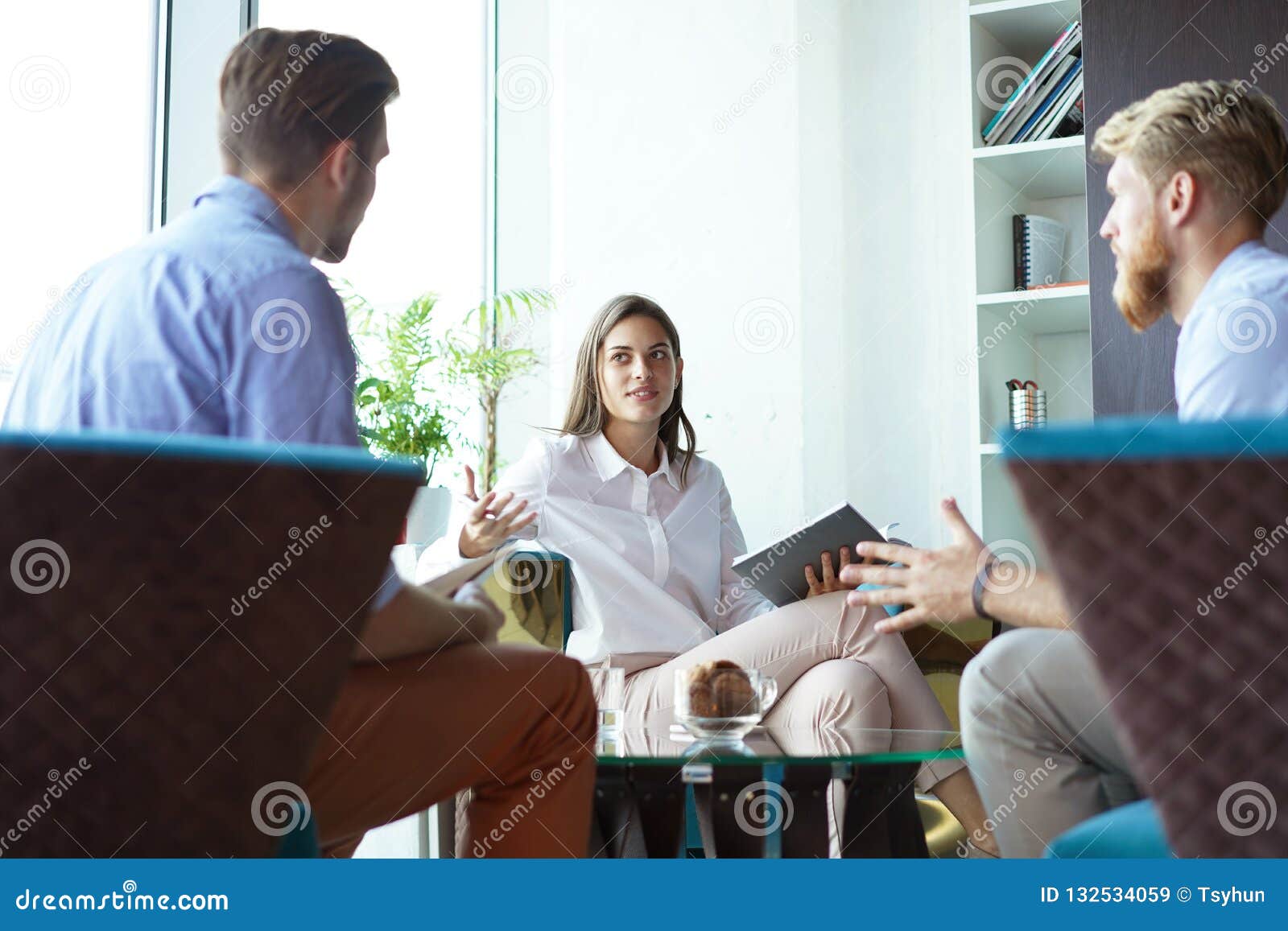 Young Colleagues in Smart Casual Wear Working while Spending Time in ...