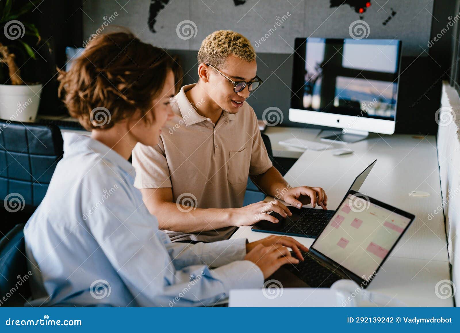 Young Colleagues Using Laptops during Meeting in Office Stock Photo ...
