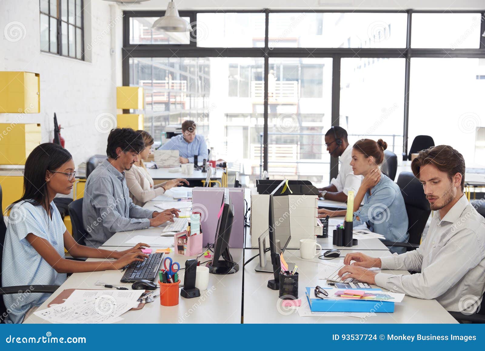 Young Colleagues Working in a Busy Open Plan Office Stock Photo - Image ...