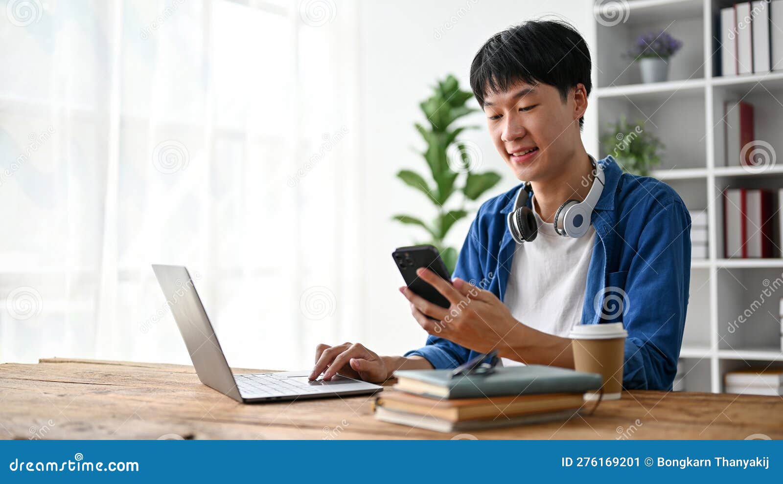 Young College Student Using Smartphone while Study in the Study Room ...