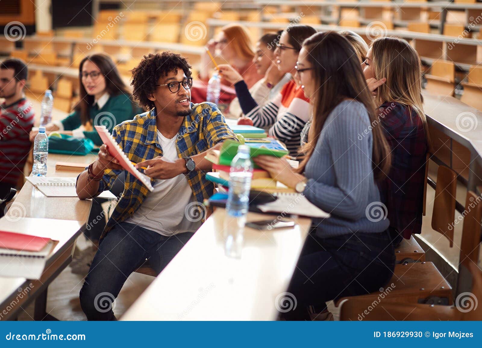 Young College Students Branstorming and Comparing Notes Stock Photo ...