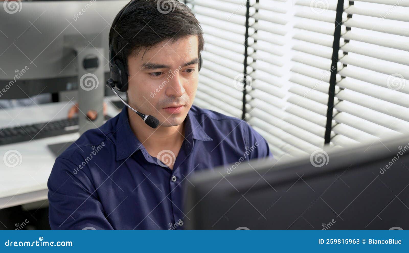 Young Competent Asian Male Call Center Agent Working in the Office ...