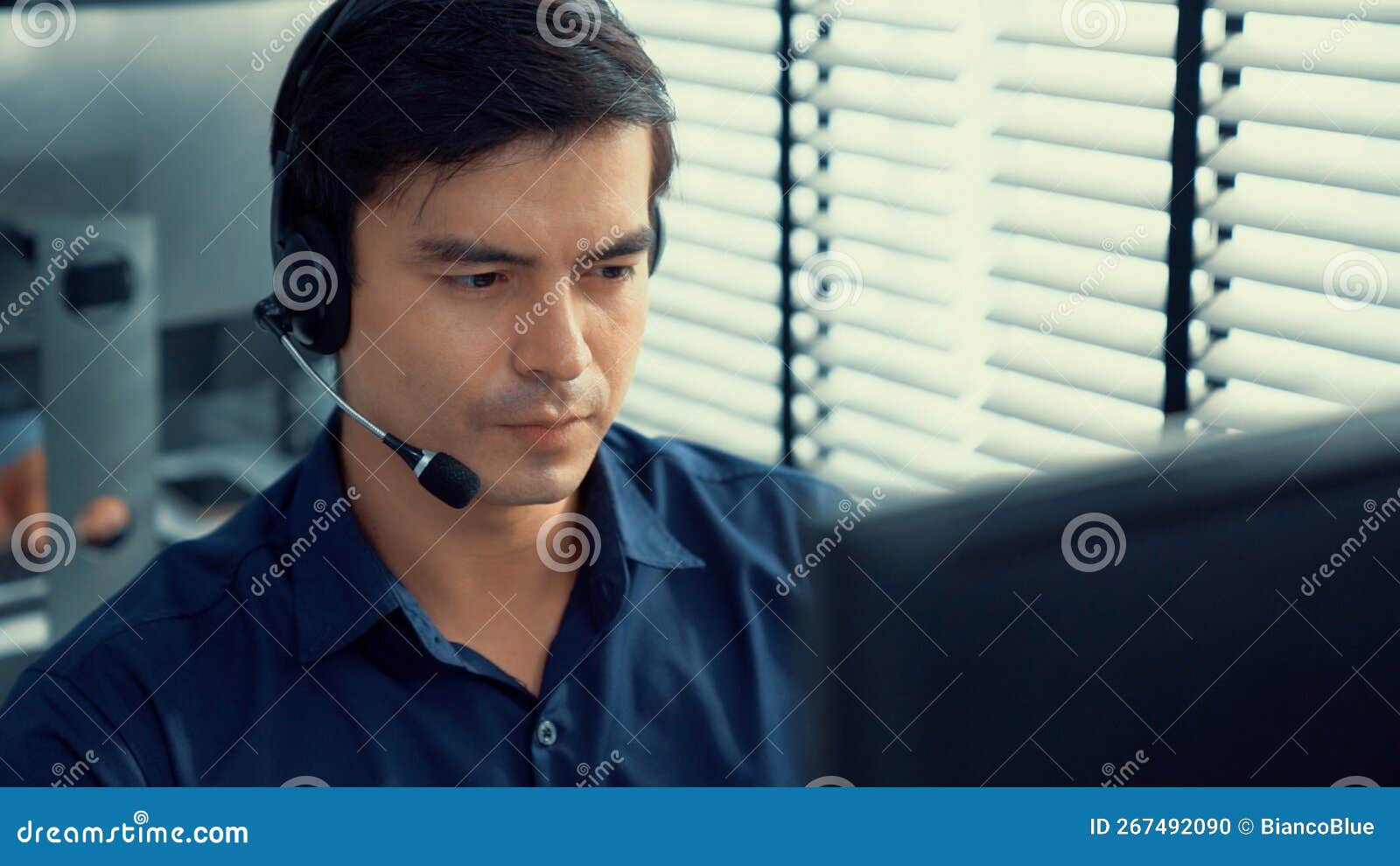 Young Competent Asian Male Call Center Agent Working in the Office ...