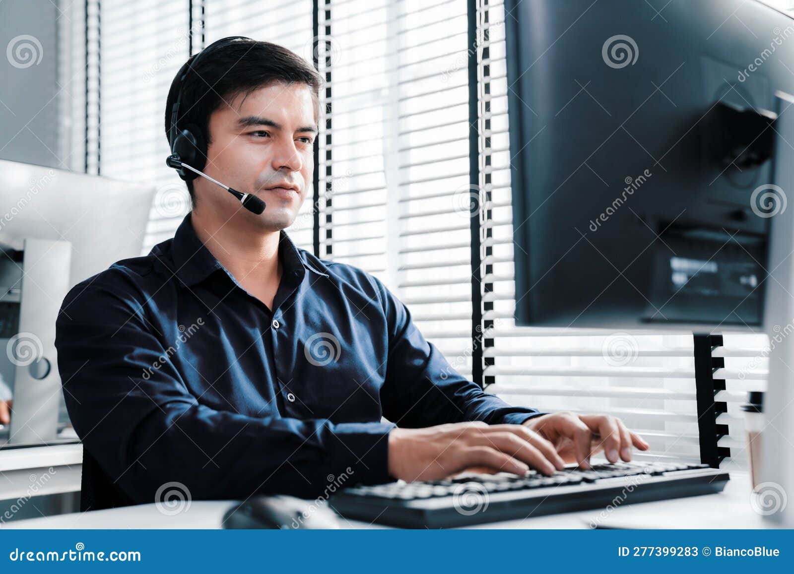 Young Competent Asian Male Call Center Agent Working in the Office ...