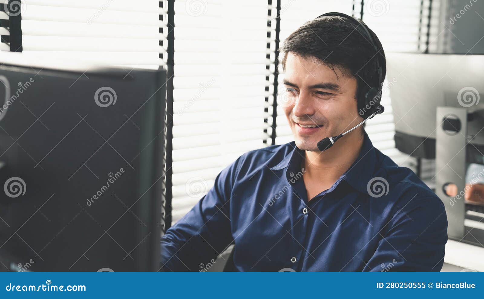 Young Competent Asian Male Call Center Agent Working in the Office ...