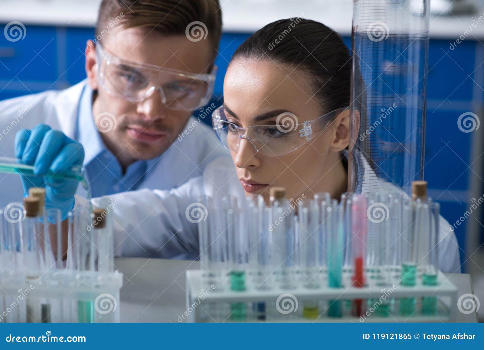 Young Concentrated Biologists Working with the Vials Focusing on it ...
