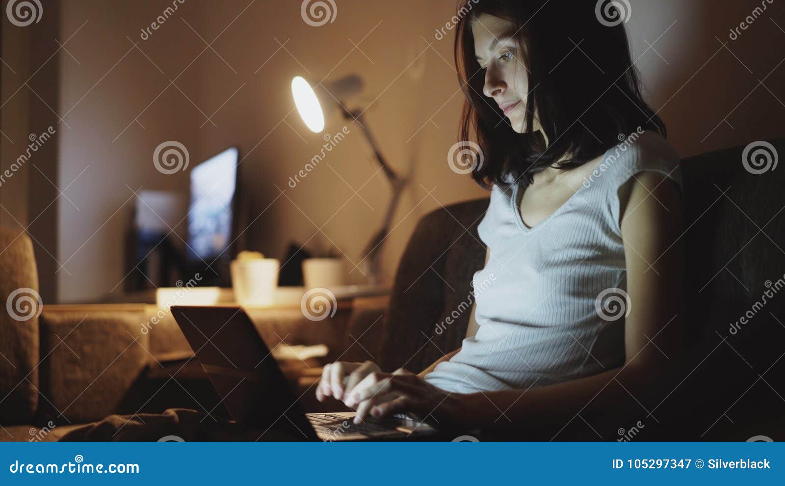 Young Concentrated Woman Using Laptop Computer and Typing Message at ...