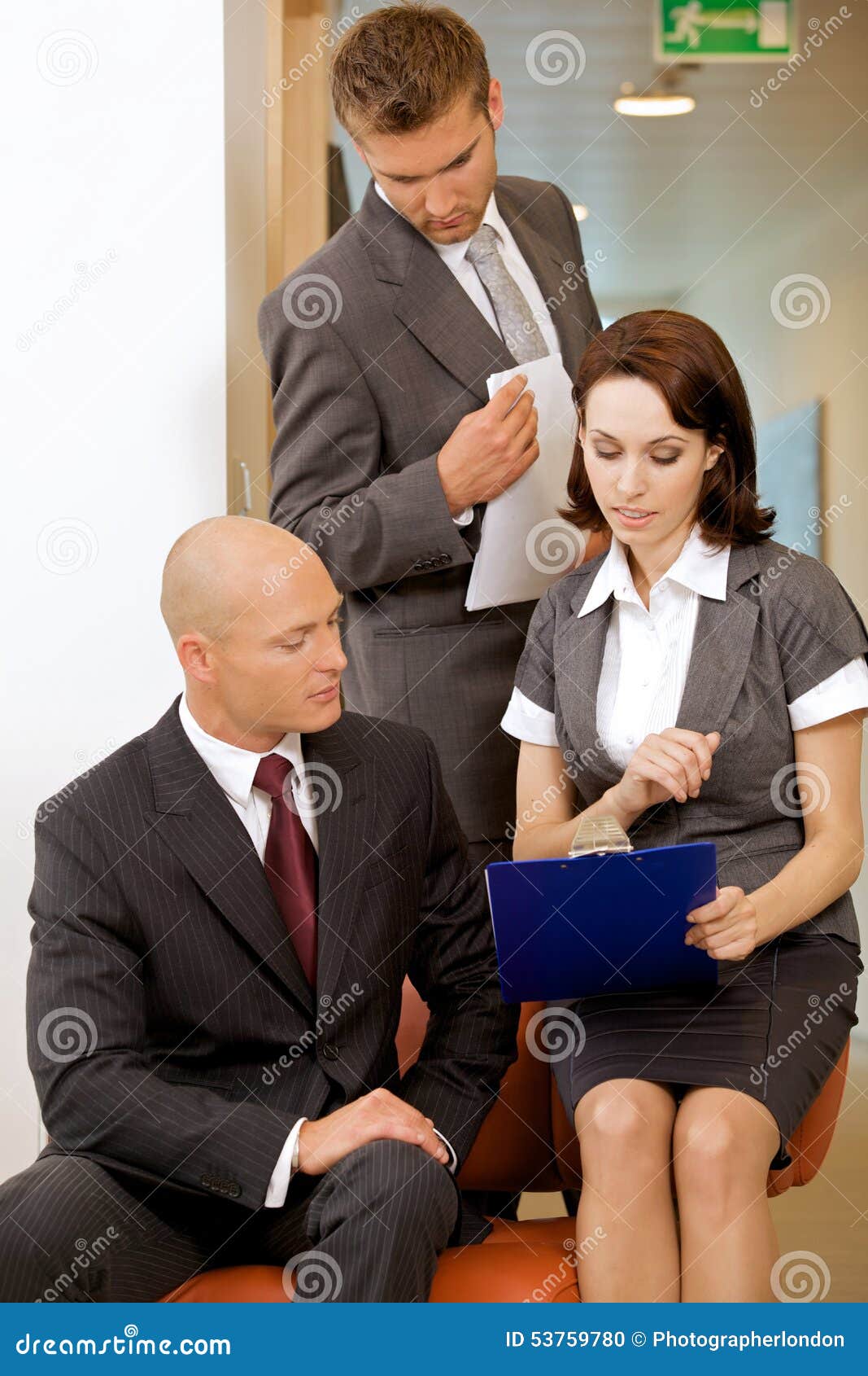 Young Confident Boss and His Secretary Looking on Documents Stock Photo ...