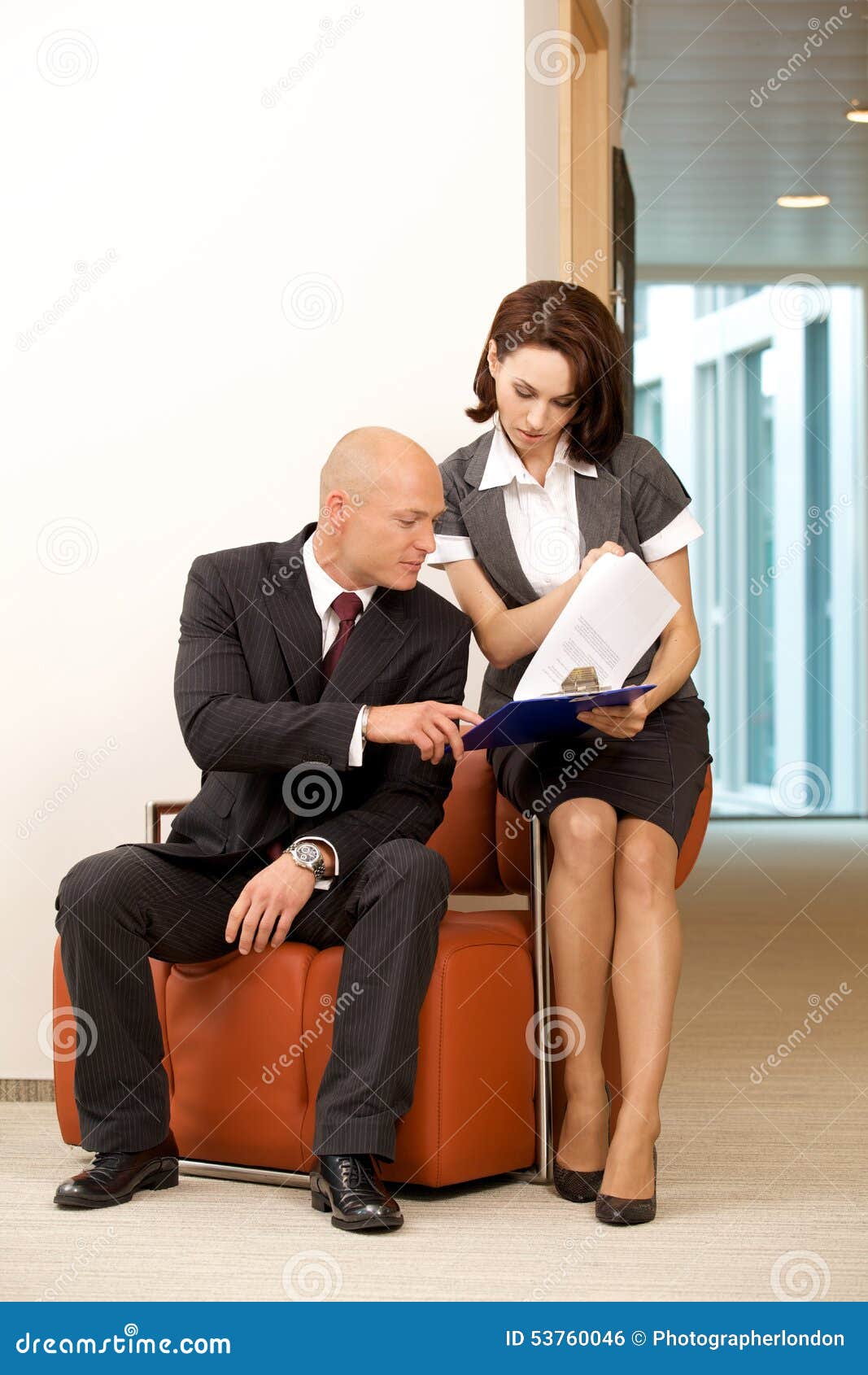 Young Confident Boss and His Secretary Looking on Documents Stock Photo ...