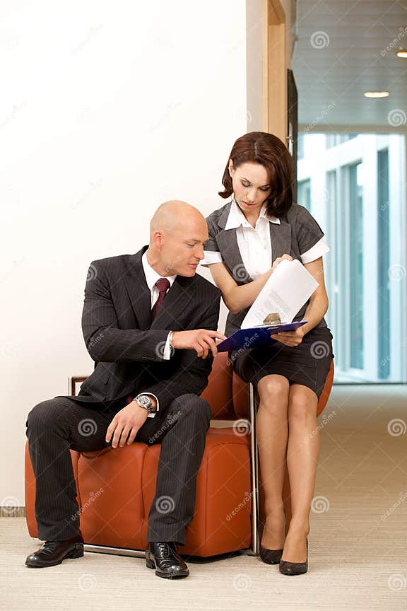 Young Confident Boss and His Secretary Looking on Documents Stock Photo ...