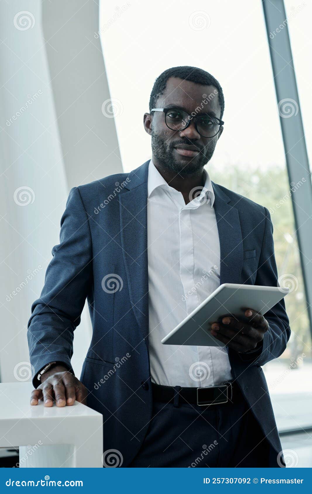 Young Confident Broker or Chief Executive Officer in Elegant Suit Using ...