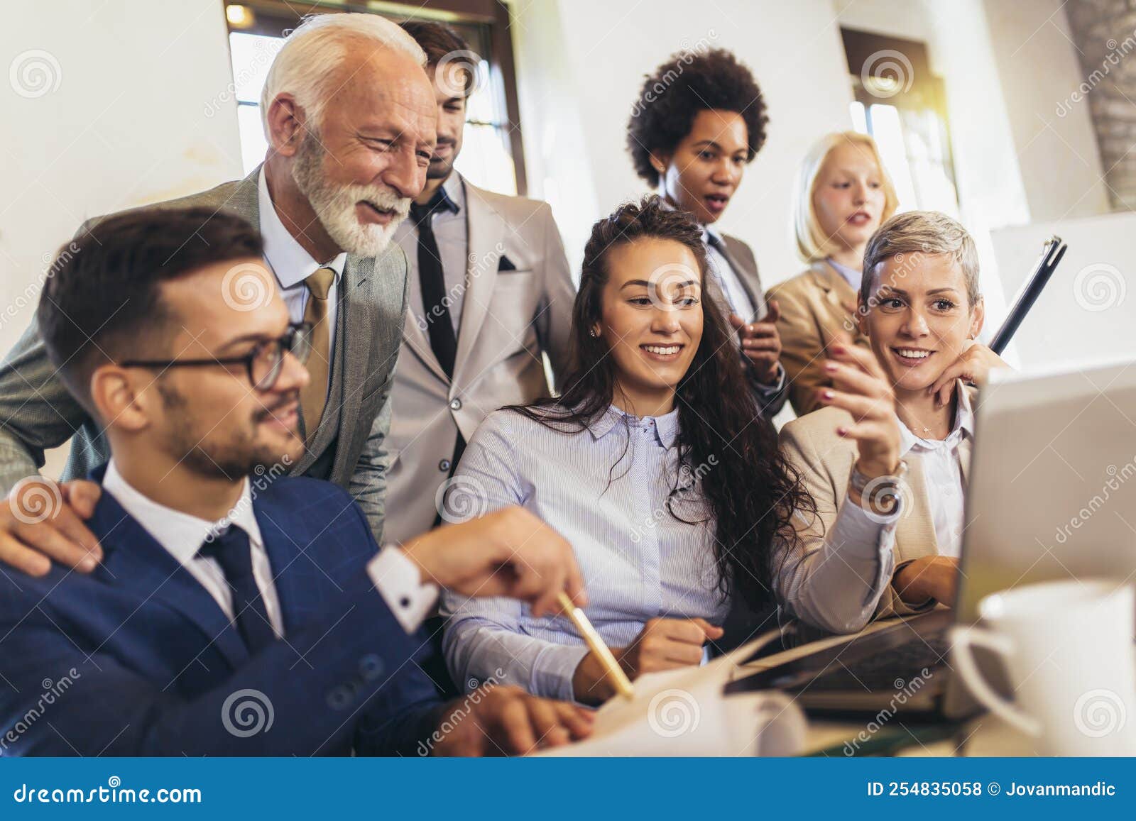 Young Confident Business People Analyzing Data Using Computer while ...