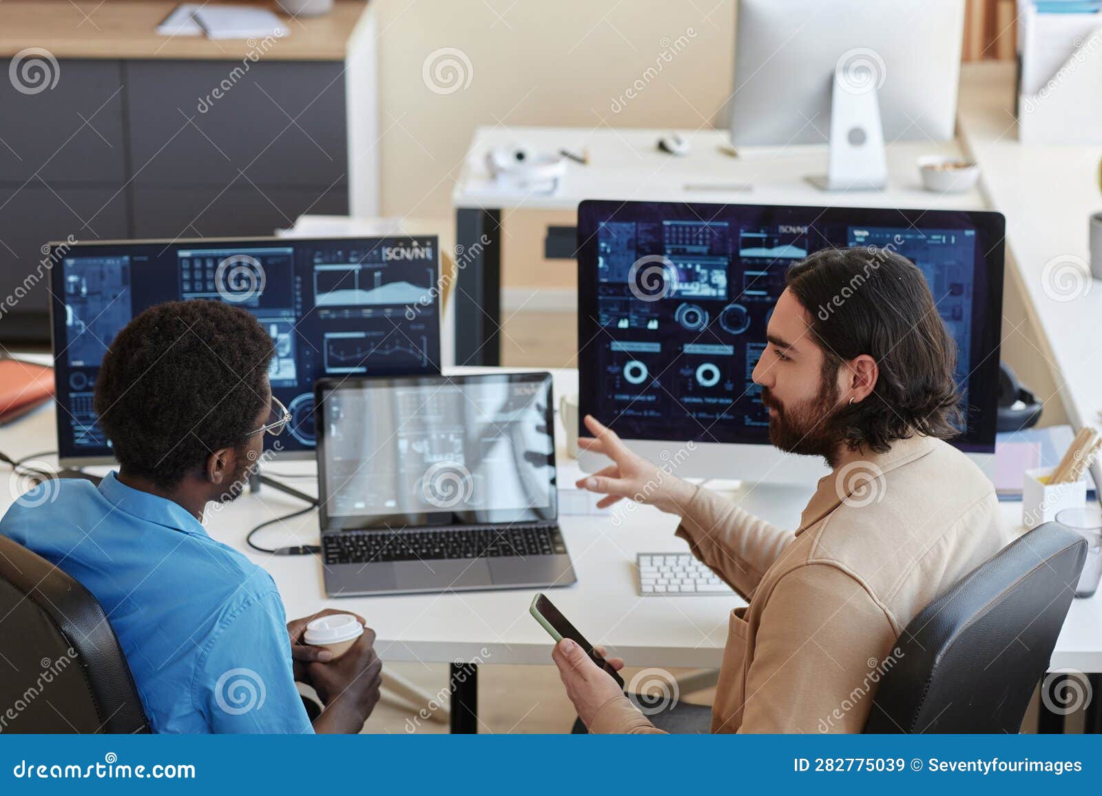 Young Confident it Engineer Explaining Graphic Data To His Colleague ...