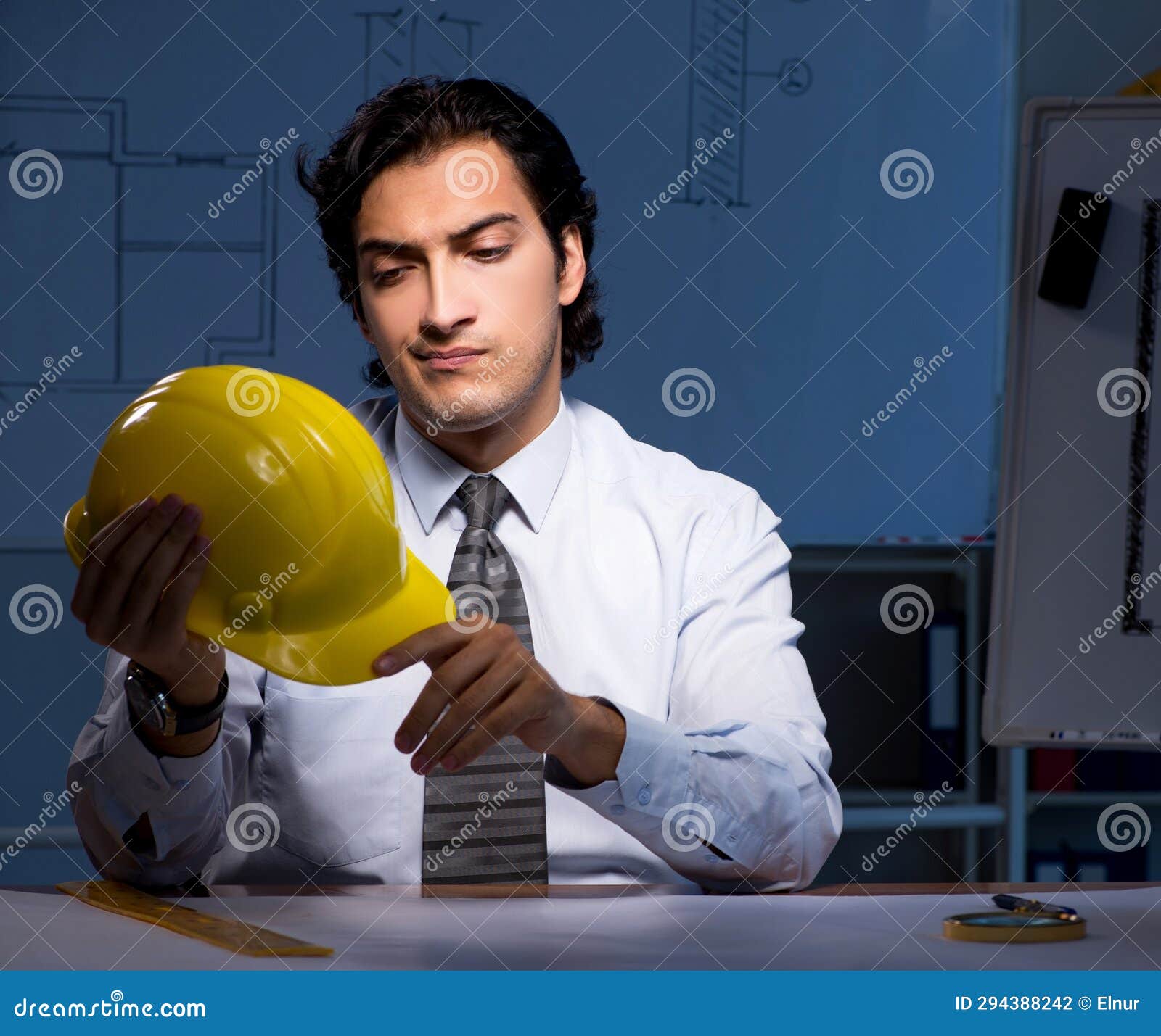 Young Construction Architect Working on Project at Night Stock Photo ...