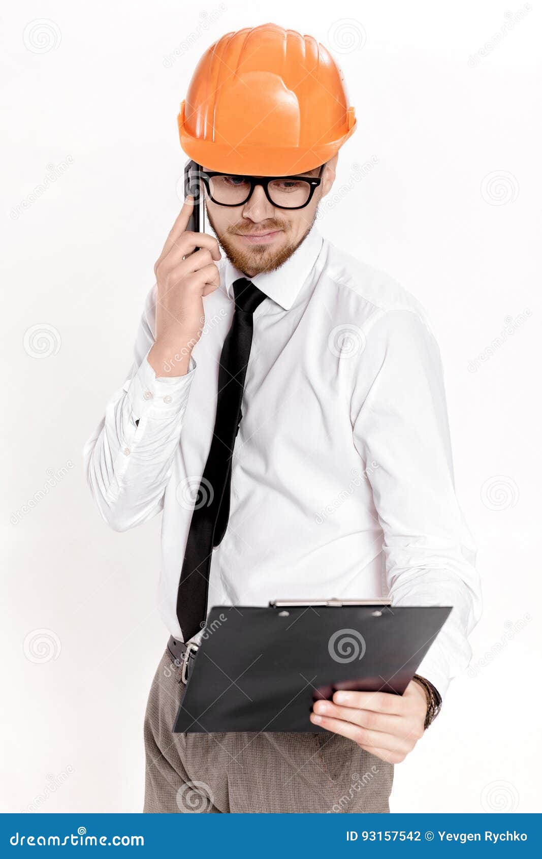 Young Construction Engineer in Orange Helmet with Folder Talking on ...