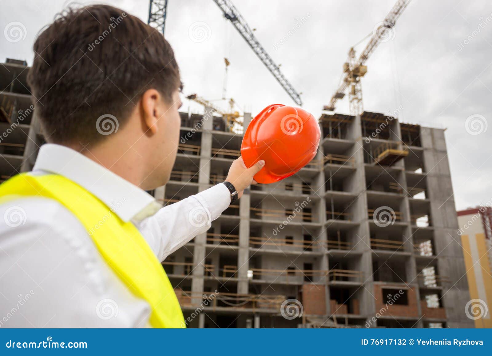 Young Construction Engineer Pointing at Building Under Construct Stock ...