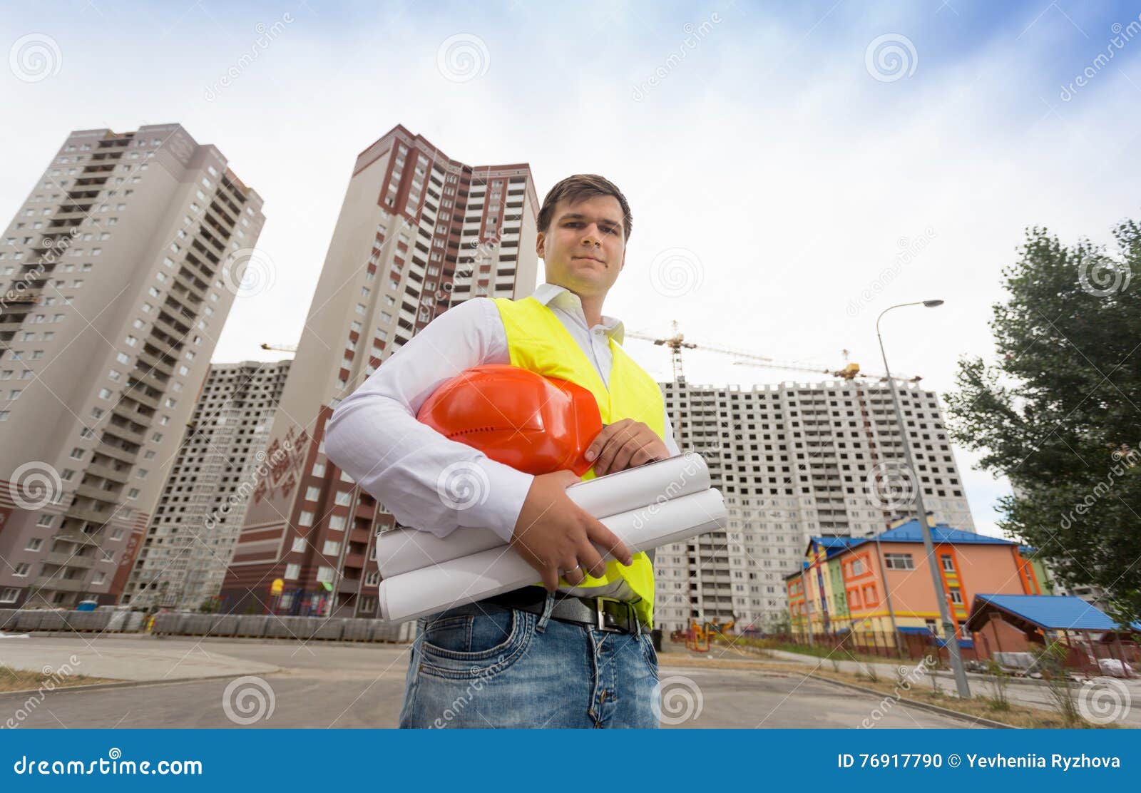 Young Construction Engineer in Safety Vest Holding Hardhat Stock Photo ...