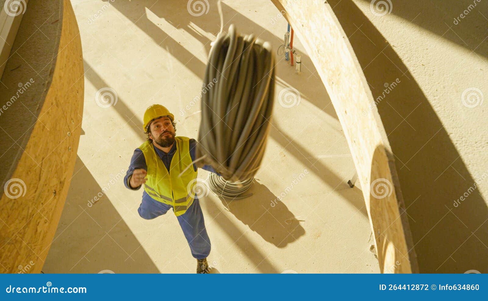 Young Contractor Catches Electrical Installation Tubing Falling from ...