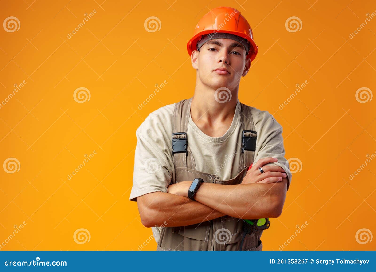 Young Construction Worker in Helmet and Uniform Posing on Yellow ...