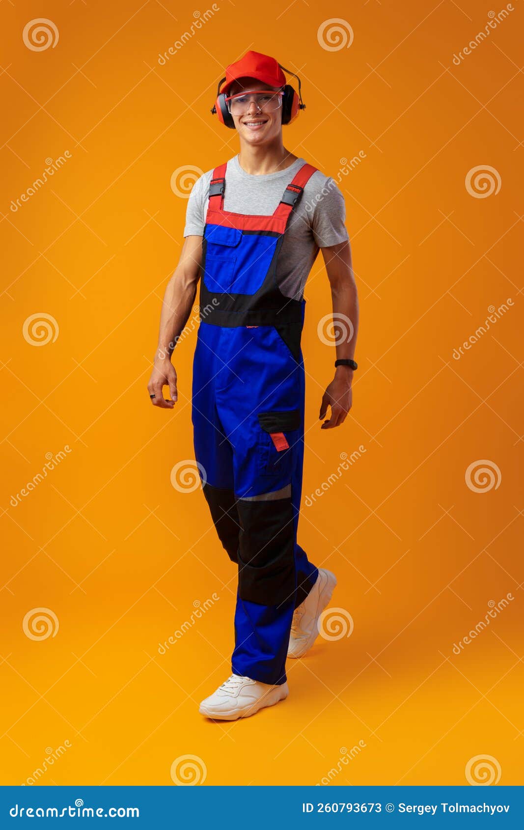 Young Construction Worker in Uniform Posing on Yellow Background in ...