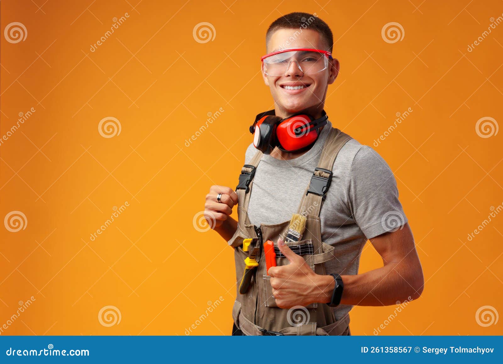 Young Construction Worker in Uniform Posing on Yellow Background in ...