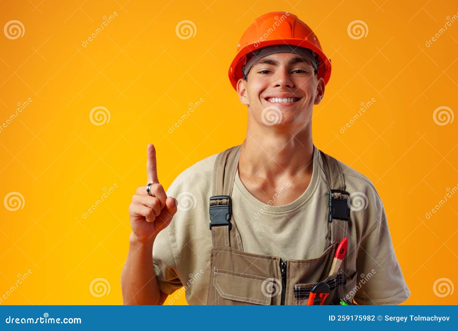 Young Construction Worker in Uniform Posing on Yellow Background in ...