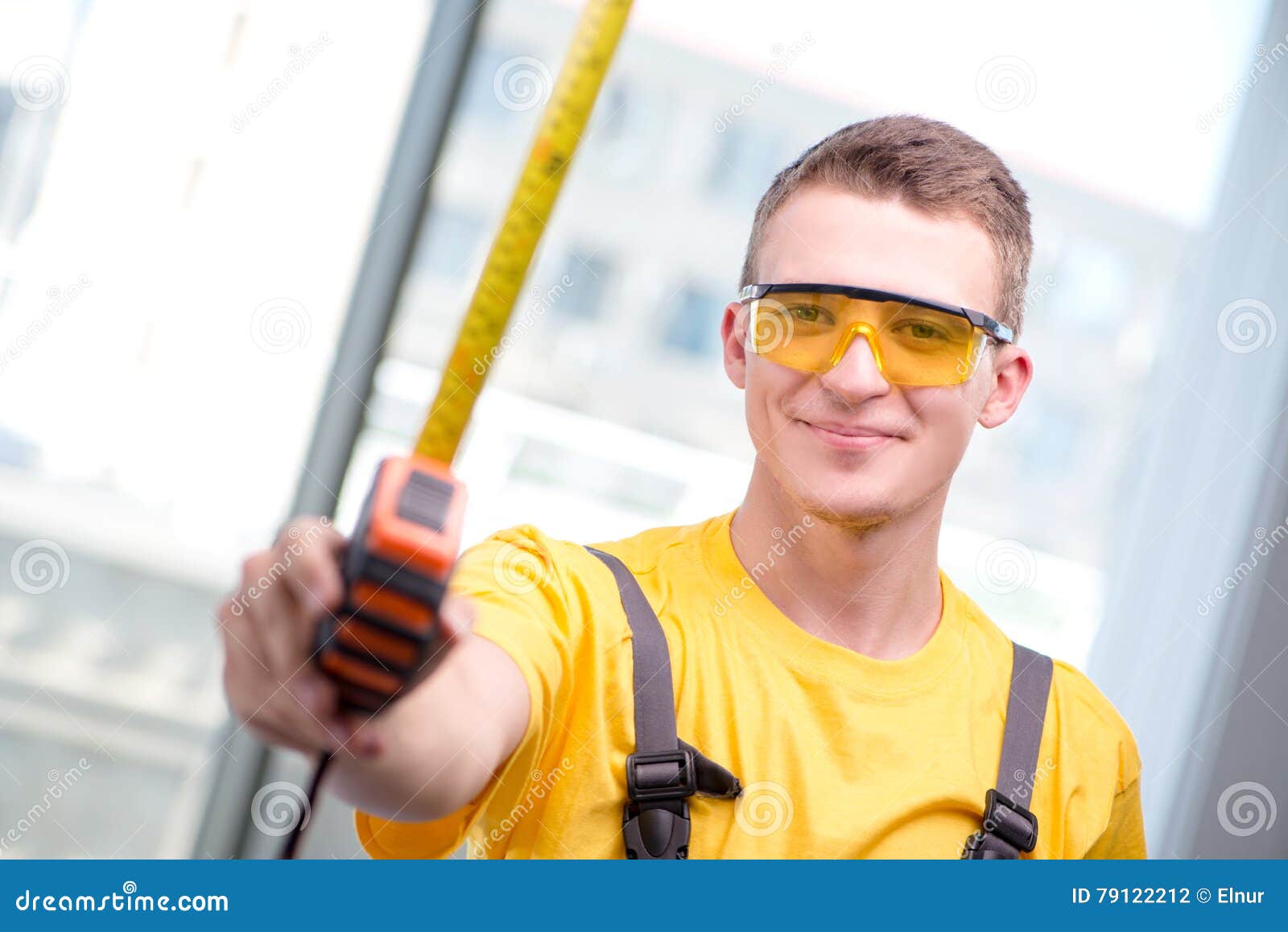 The Young Construction Worker in Yellow Coveralls Stock Photo - Image ...