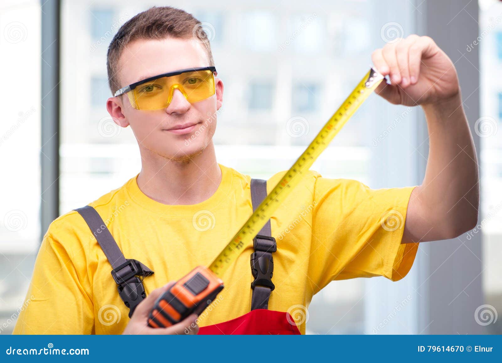 The Young Construction Worker in Yellow Coveralls Stock Photo - Image ...