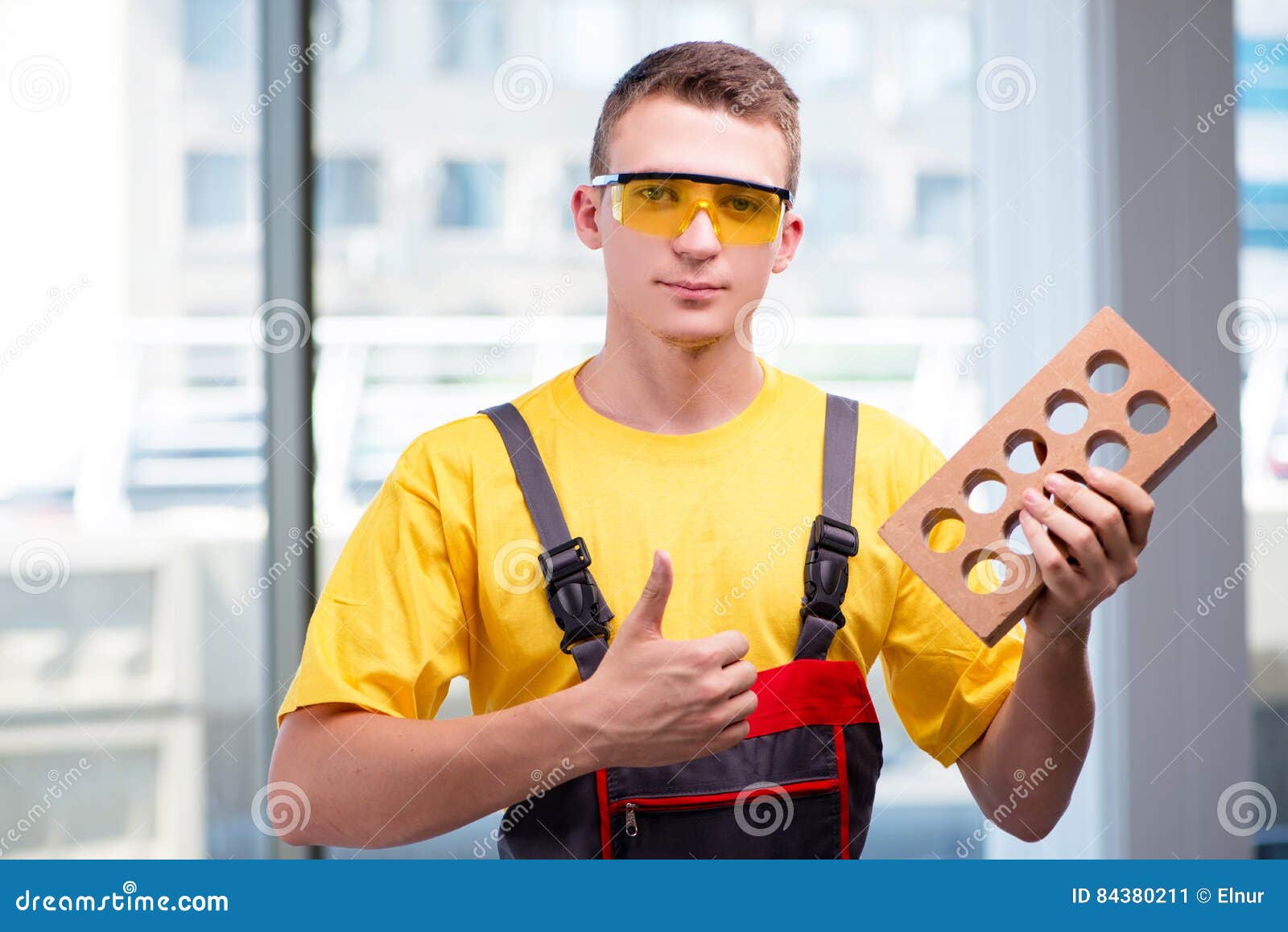The Young Construction Worker in Yellow Coveralls Stock Image - Image ...