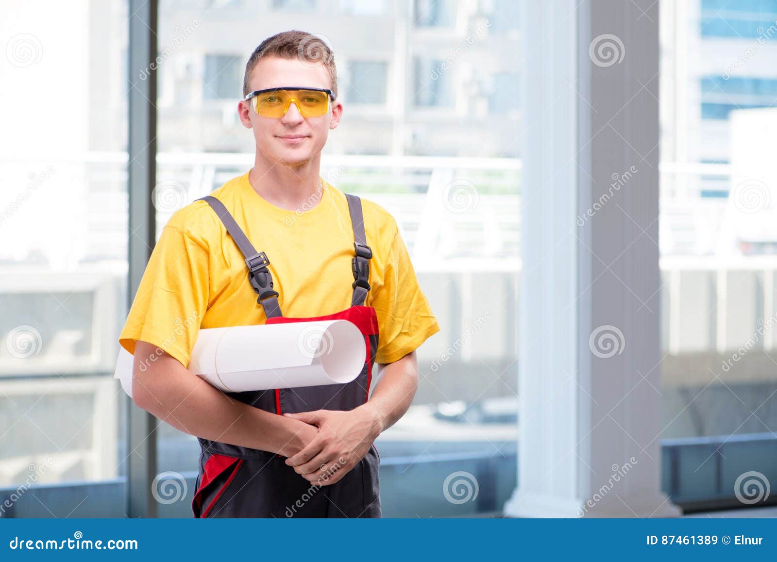 The Young Construction Worker in Yellow Coveralls Stock Image - Image ...