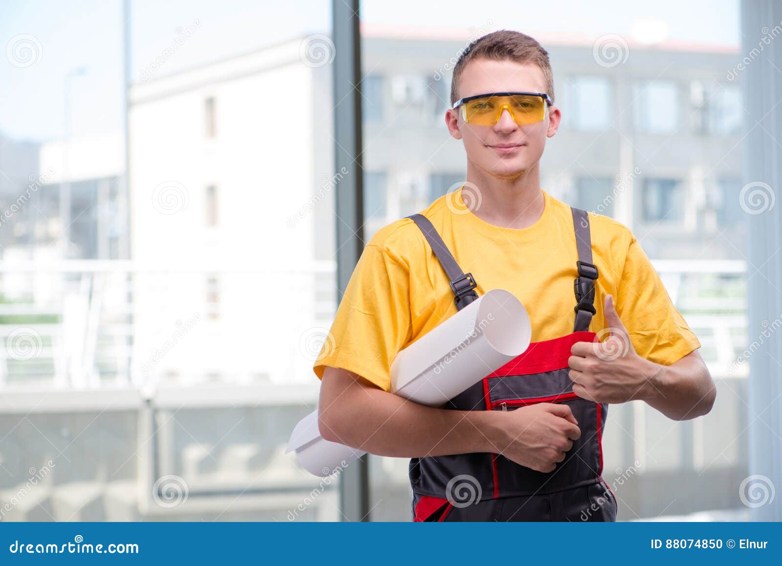 The Young Construction Worker in Yellow Coveralls Stock Photo - Image ...