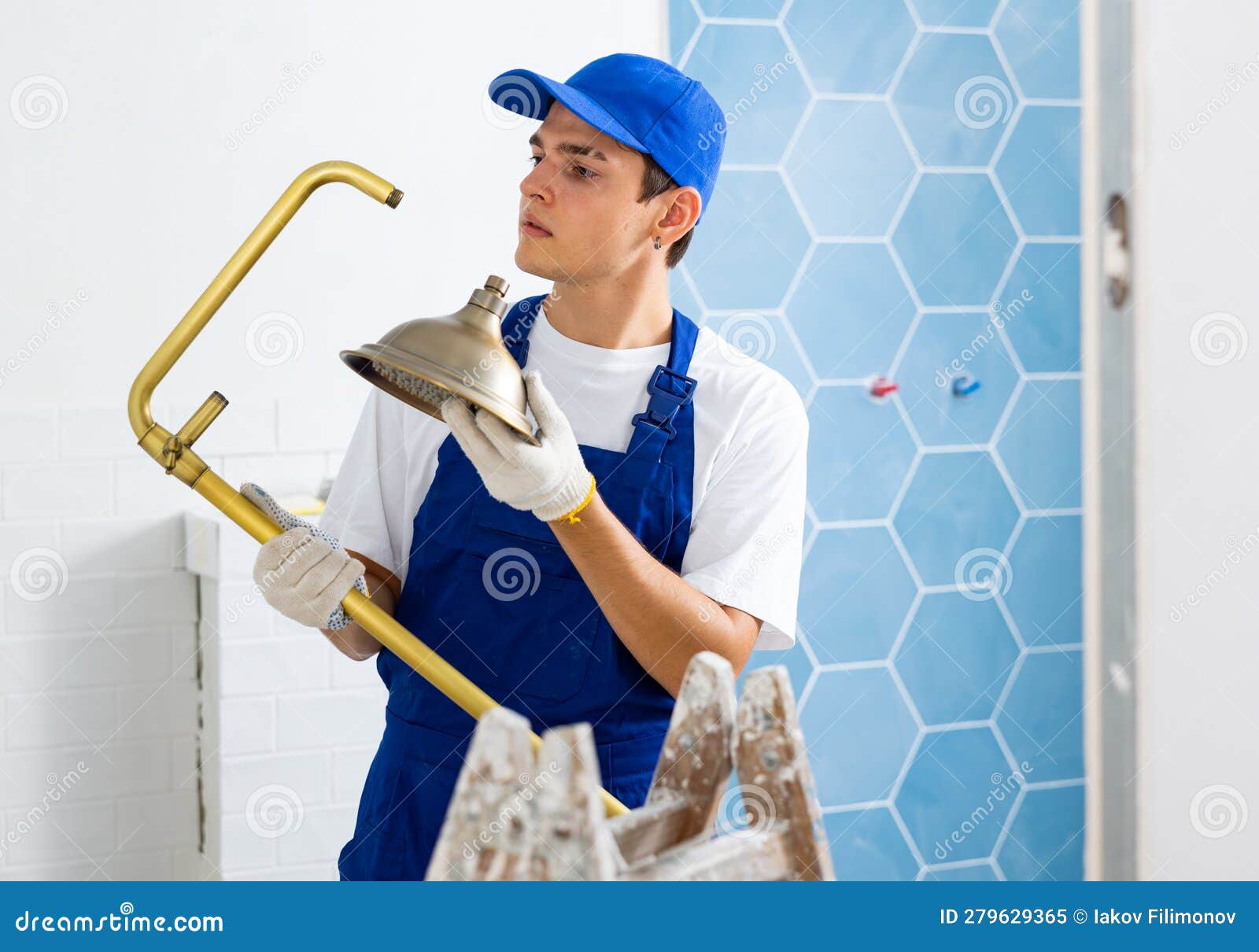 Young Contractor Preparing Shower for Installation in Building Under ...