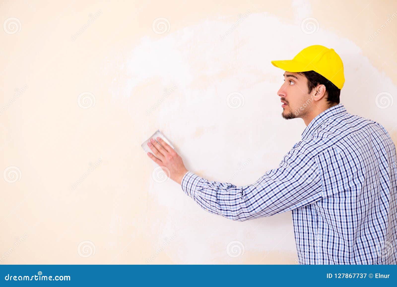 The Young Contractor Sanding Wall Down with Sandpaper Stock Image ...