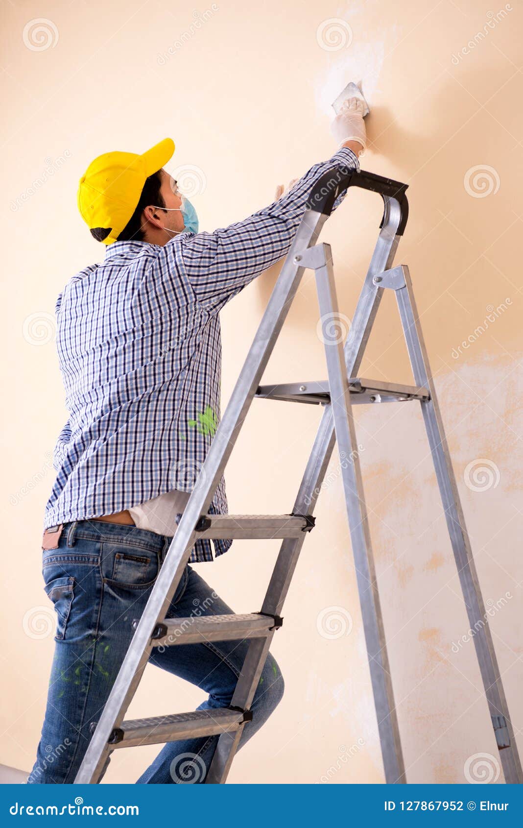 The Young Contractor Sanding Wall Down with Sandpaper Stock Photo ...