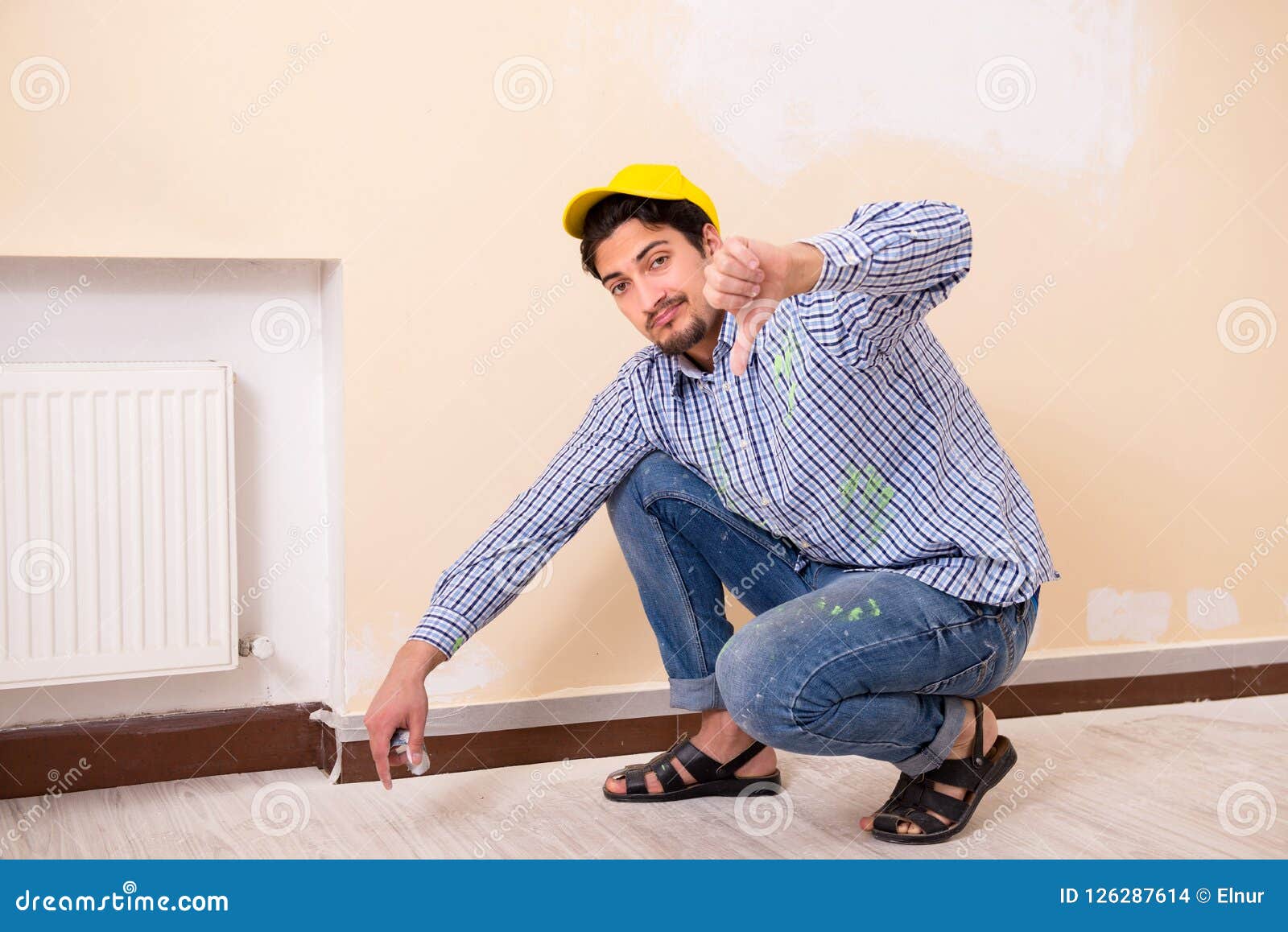The Young Contractor Sanding Wall Down with Sandpaper Stock Photo ...