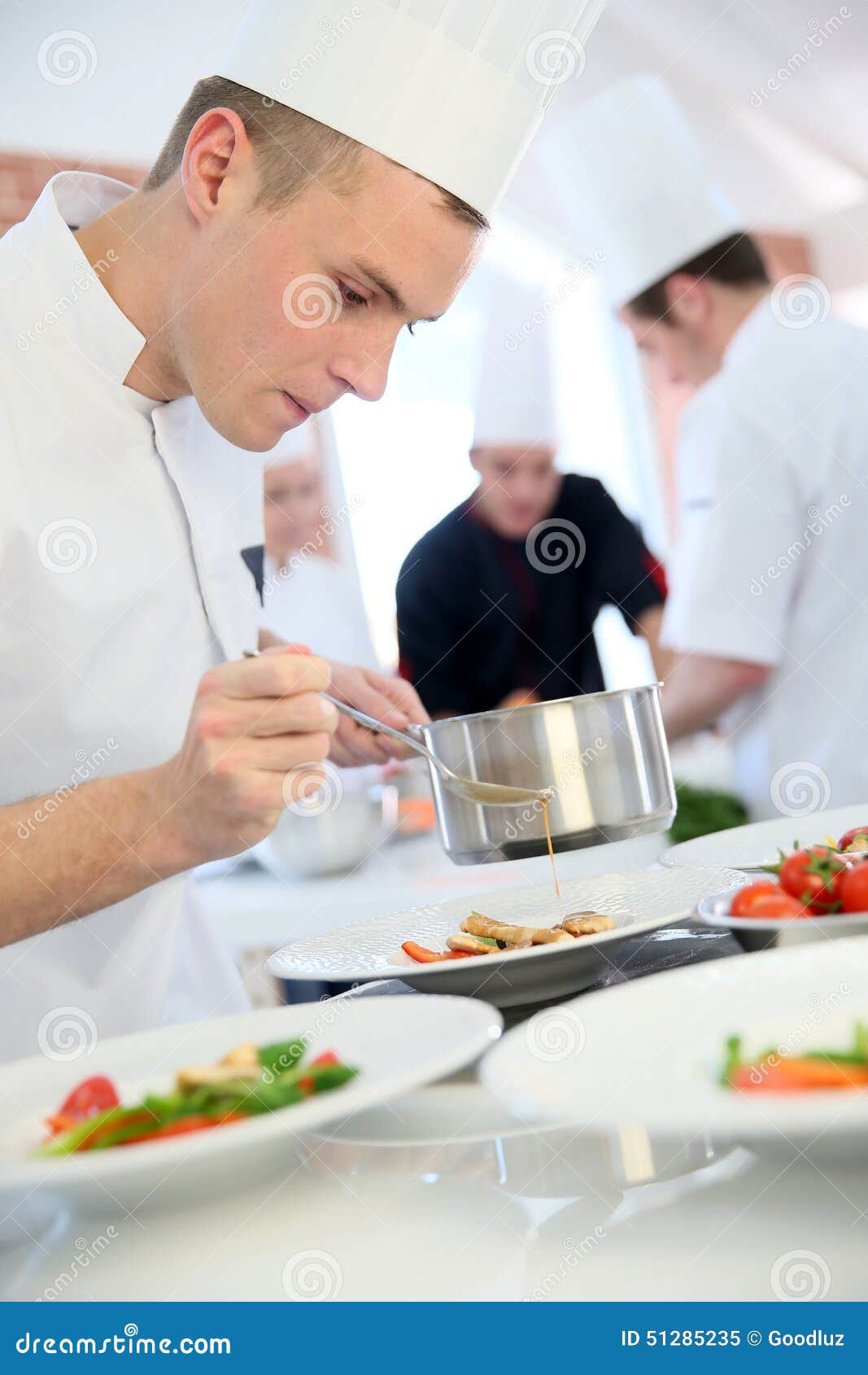 Young Cook Apprentice Pouring Sauce on Dish Stock Image - Image of ...