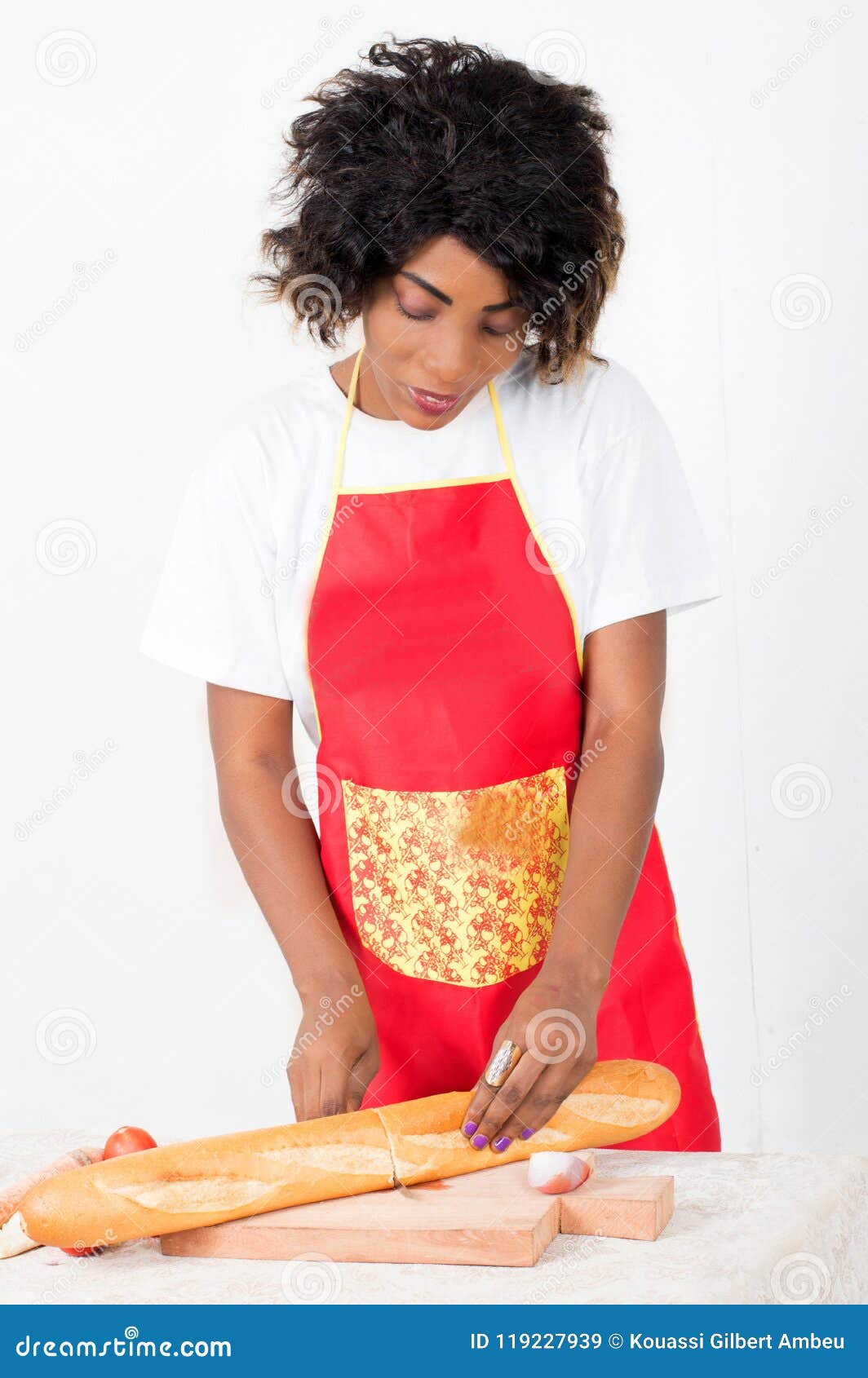 Young cook breaking bread. stock image. Image of african - 119227939