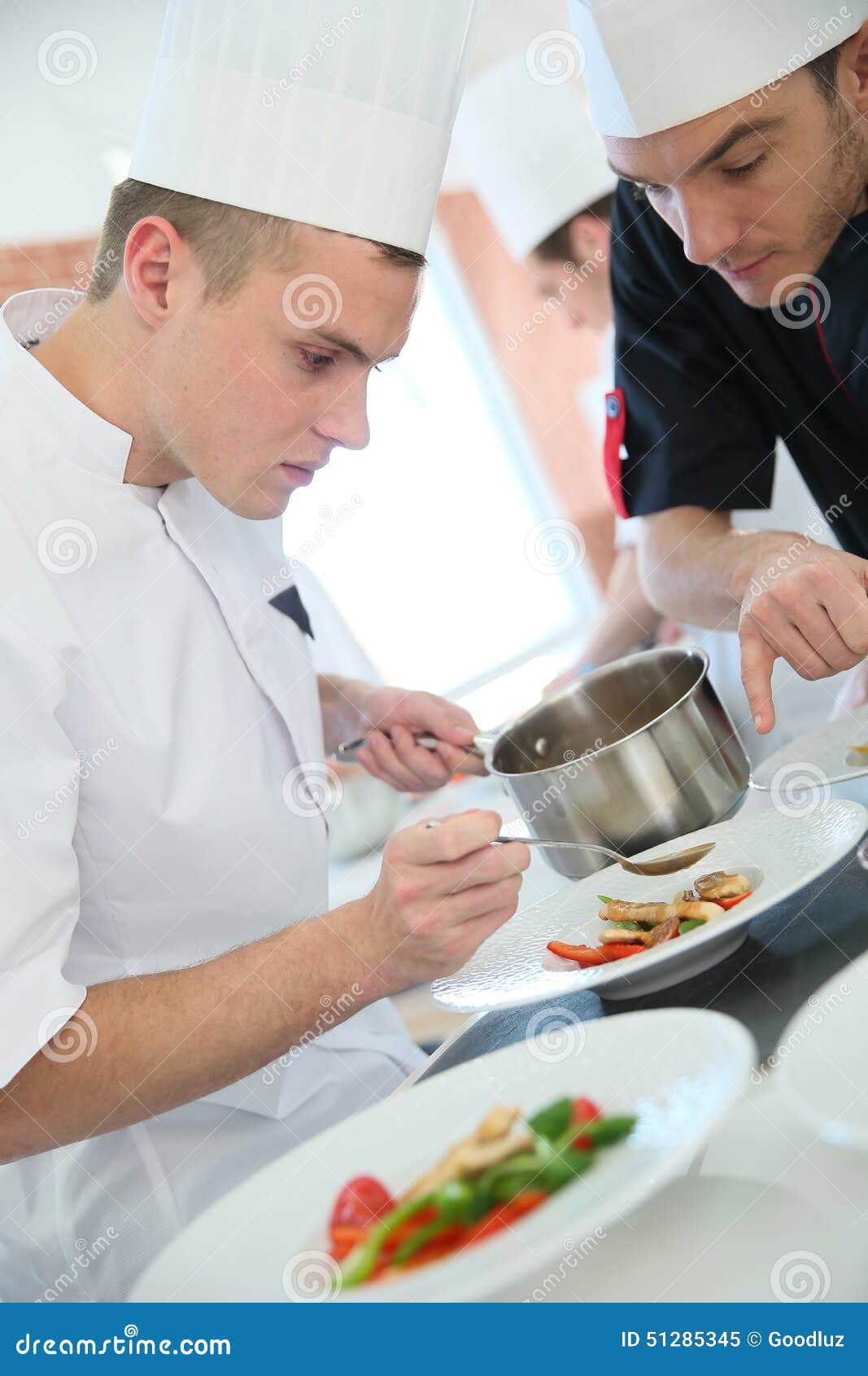 Young Cooking Chef Preparing Dish Stock Image - Image of people, group ...