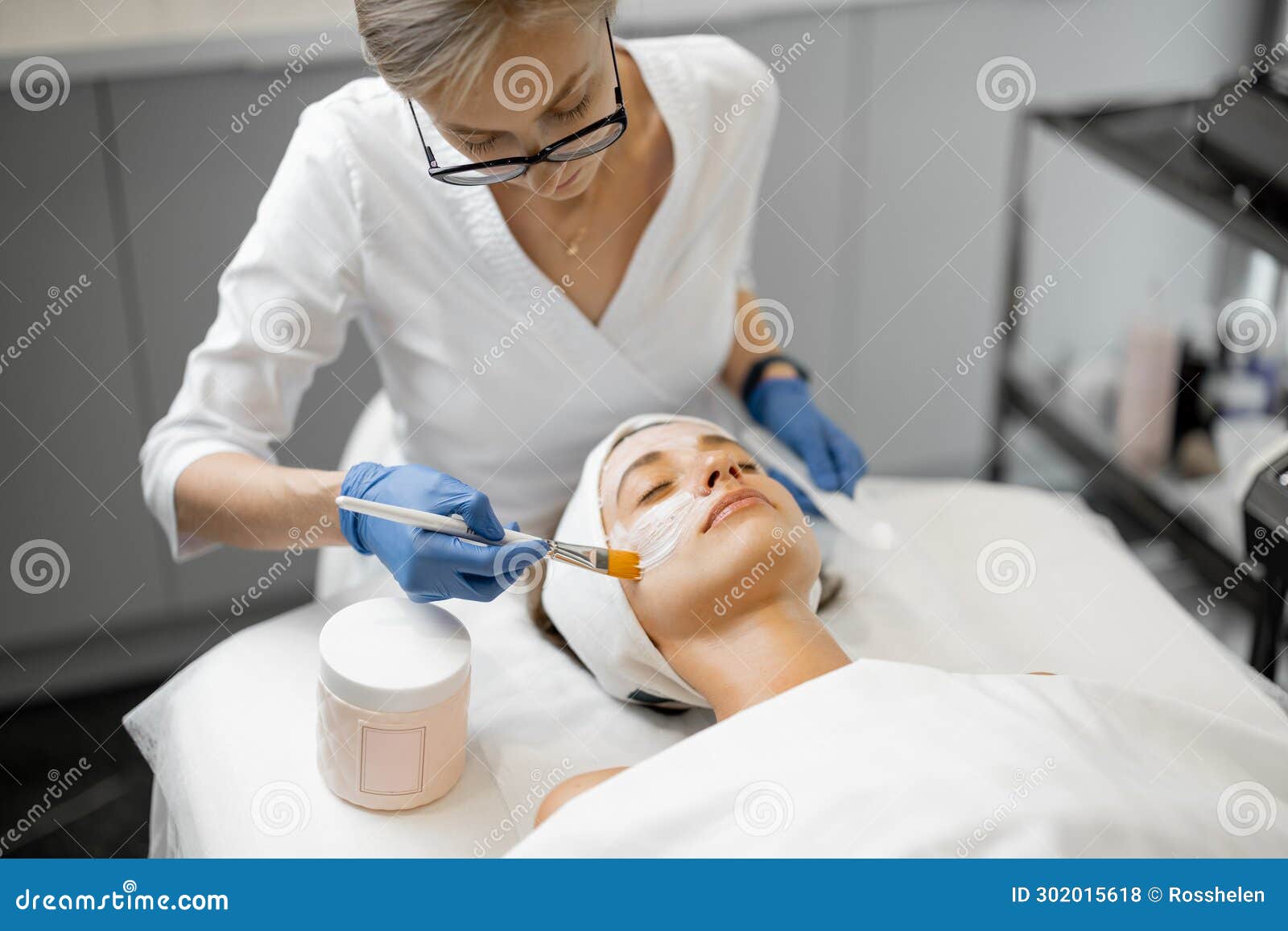 Young Cosmetologist Applies Cream To A Womanand X27 S Face In Beauty