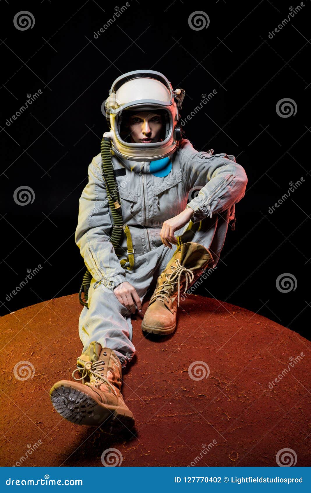 Young Cosmonaut in Spacesuit with Helmet Sitting on Planet Stock Photo ... Young Cosmonaut in Spacesuit with Helmet Sitting on Planet Stock Photo ...