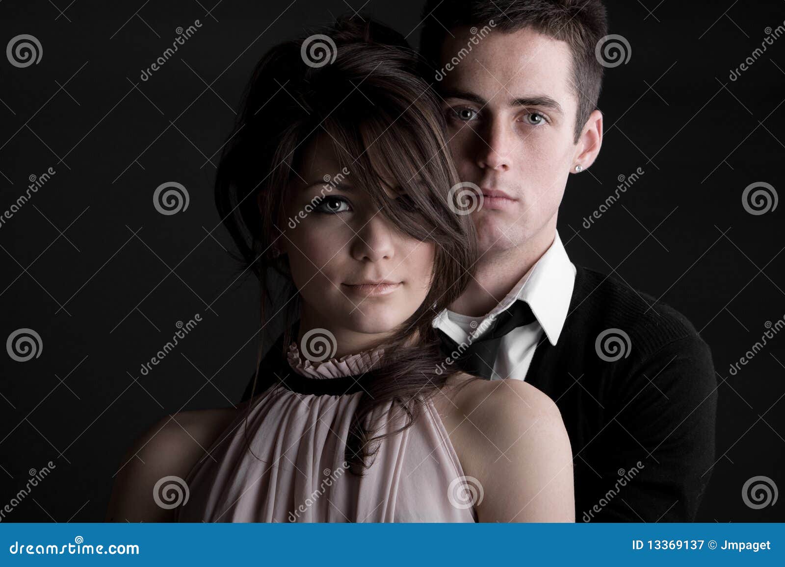 Young Couple Against Dark Background Stock Image - Image of ...