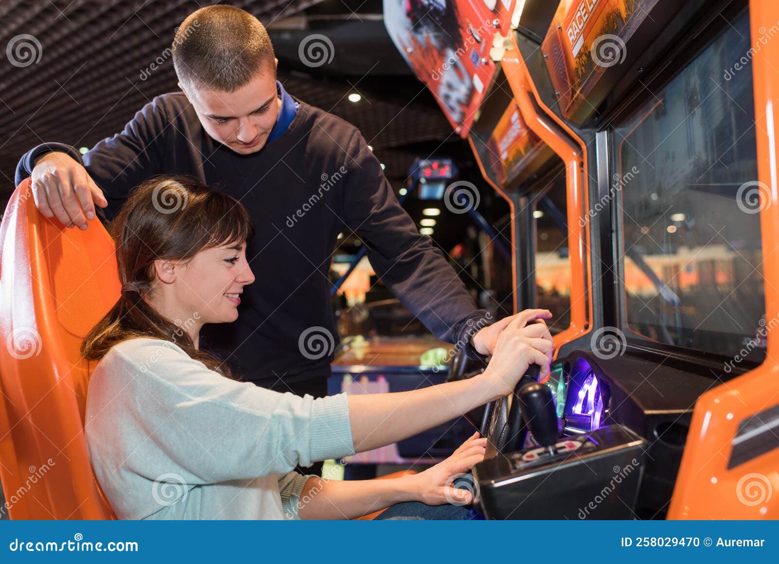 Young Couple at Arcade Driving Game Stock Photo - Image of operated ...