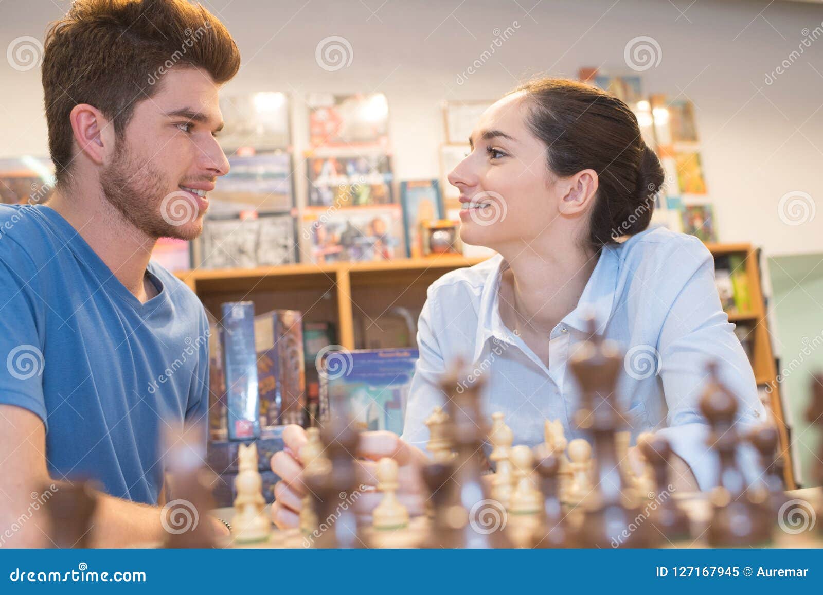 Young Couple Behind Chess Pieces Stock Image - Image of board, commerce ...
