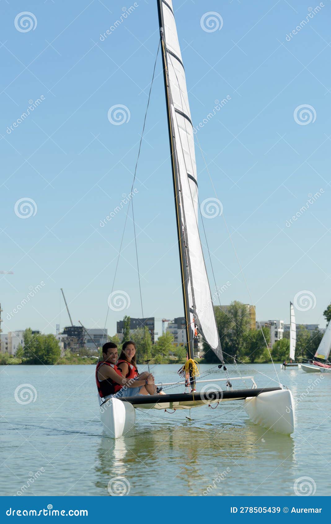 Young Couple on Board Catamaran Sailboat Stock Image - Image of ...