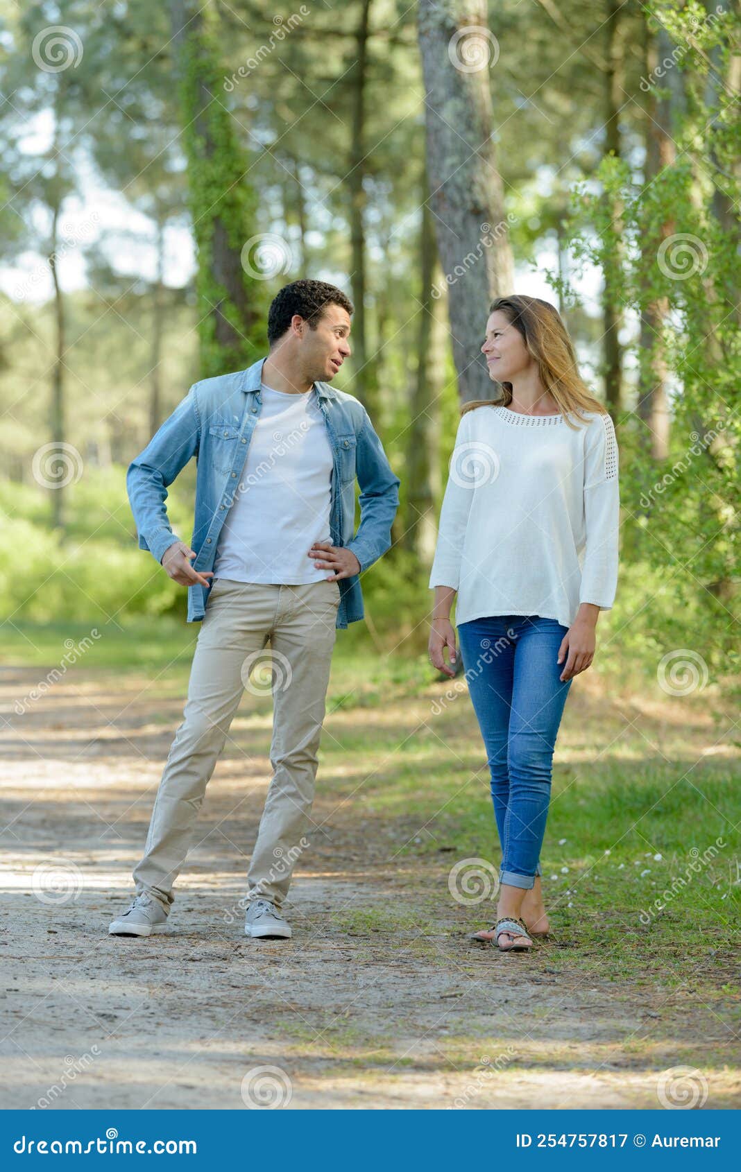 Young Couple Chatting while Walking Along Country Path Stock Image - Image of smiling, trousers ...