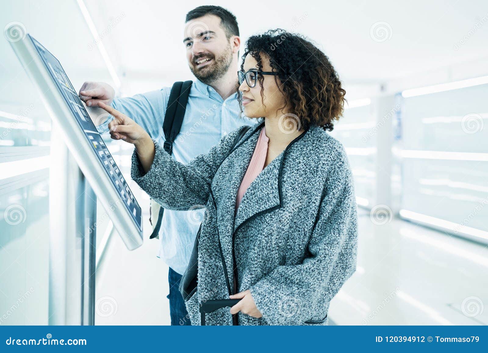 Young Couple Checking the Timetable Stock Photo - Image of departure ...