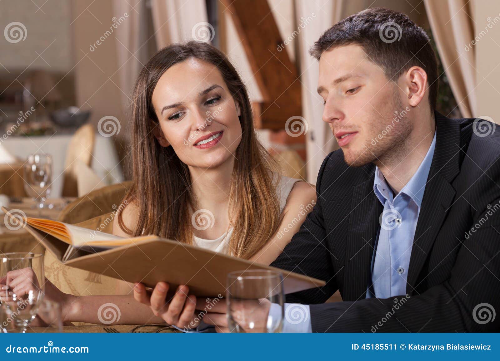 Young Couple Choosing from Menu Stock Image - Image of brunette ...
